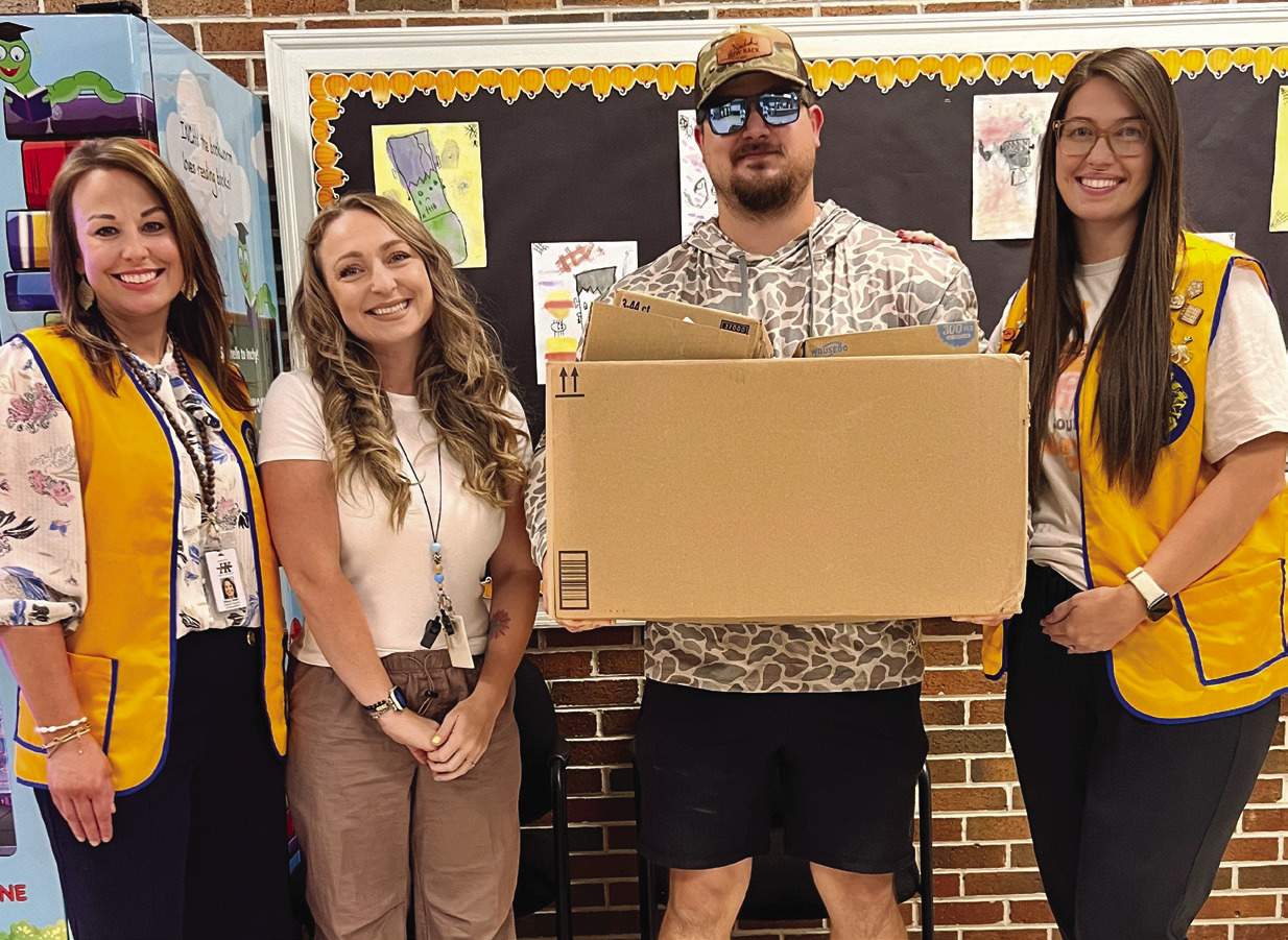 Lions Donate to Henryetta, Dewar Schools